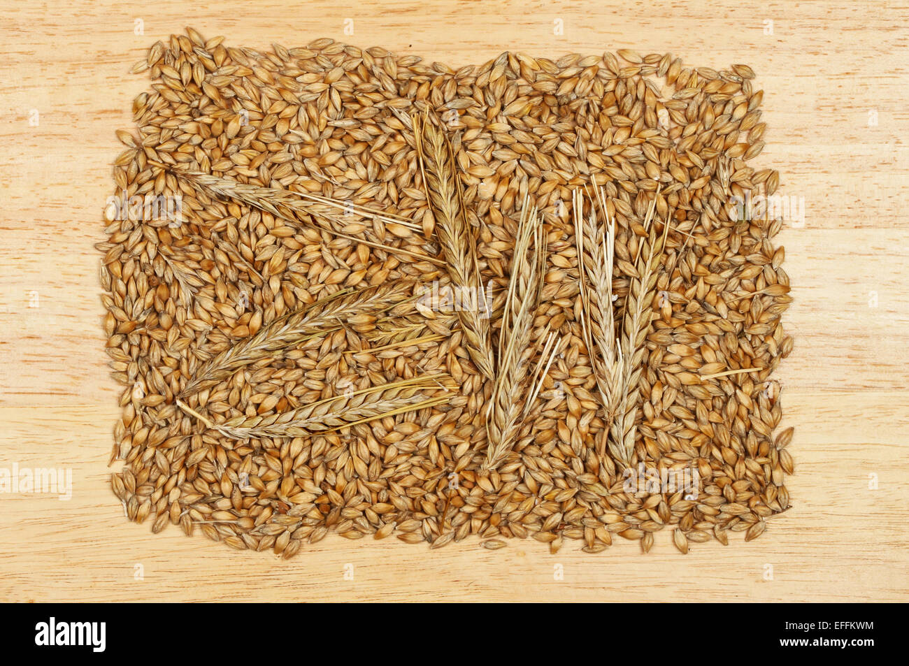 Wheat ears and grain on a wooden board Stock Photo - Alamy