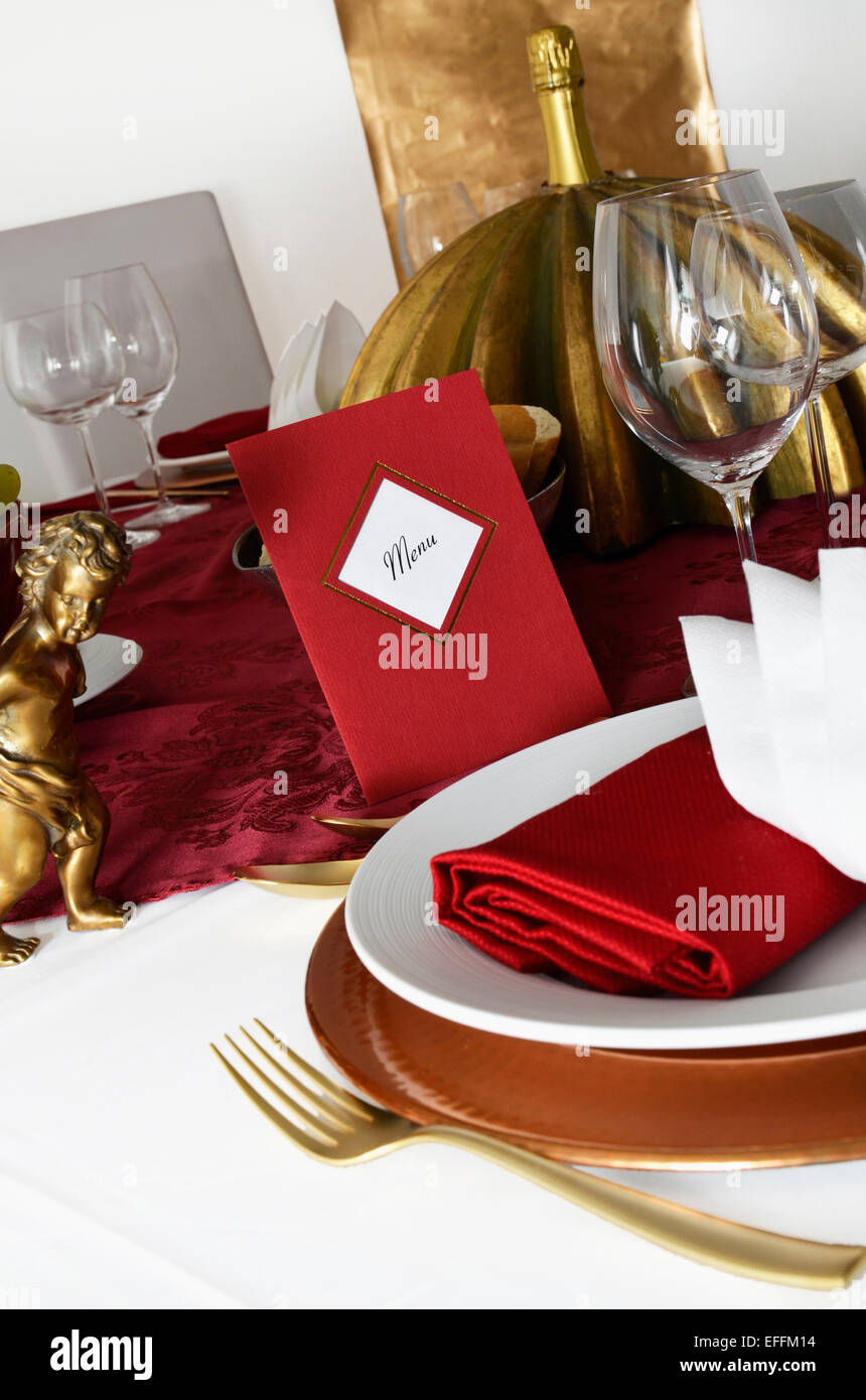 Laid table, red menu card, red and golden place setting Stock Photo - Alamy