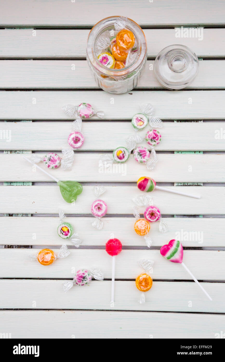 Germany, Lollipops on white wood Stock Photo - Alamy