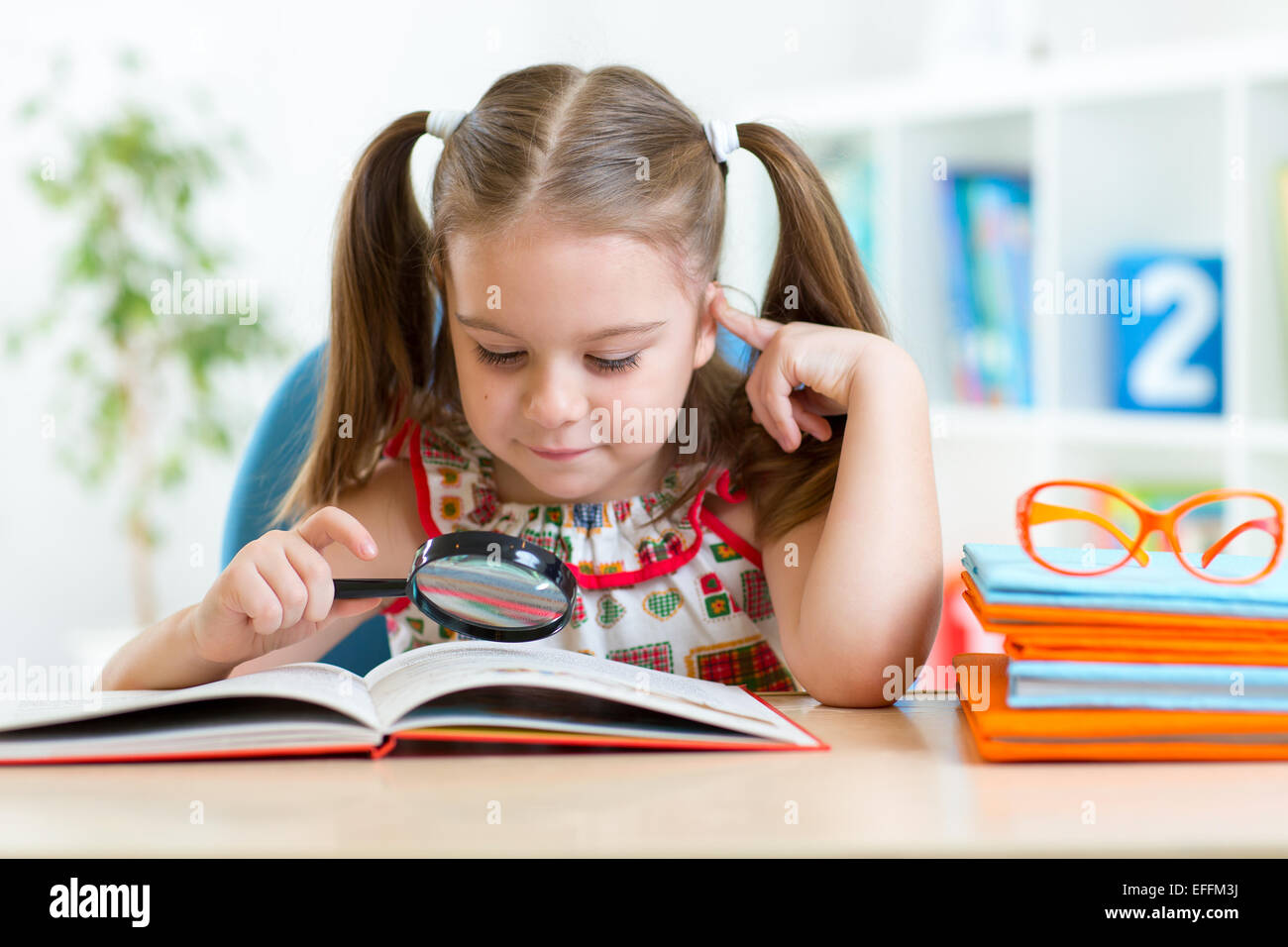 Book magnifying hi-res stock photography and images - Alamy