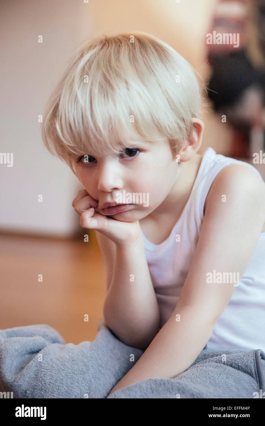 Portrait of sad little boy with head in his hand Stock Photo - Alamy
