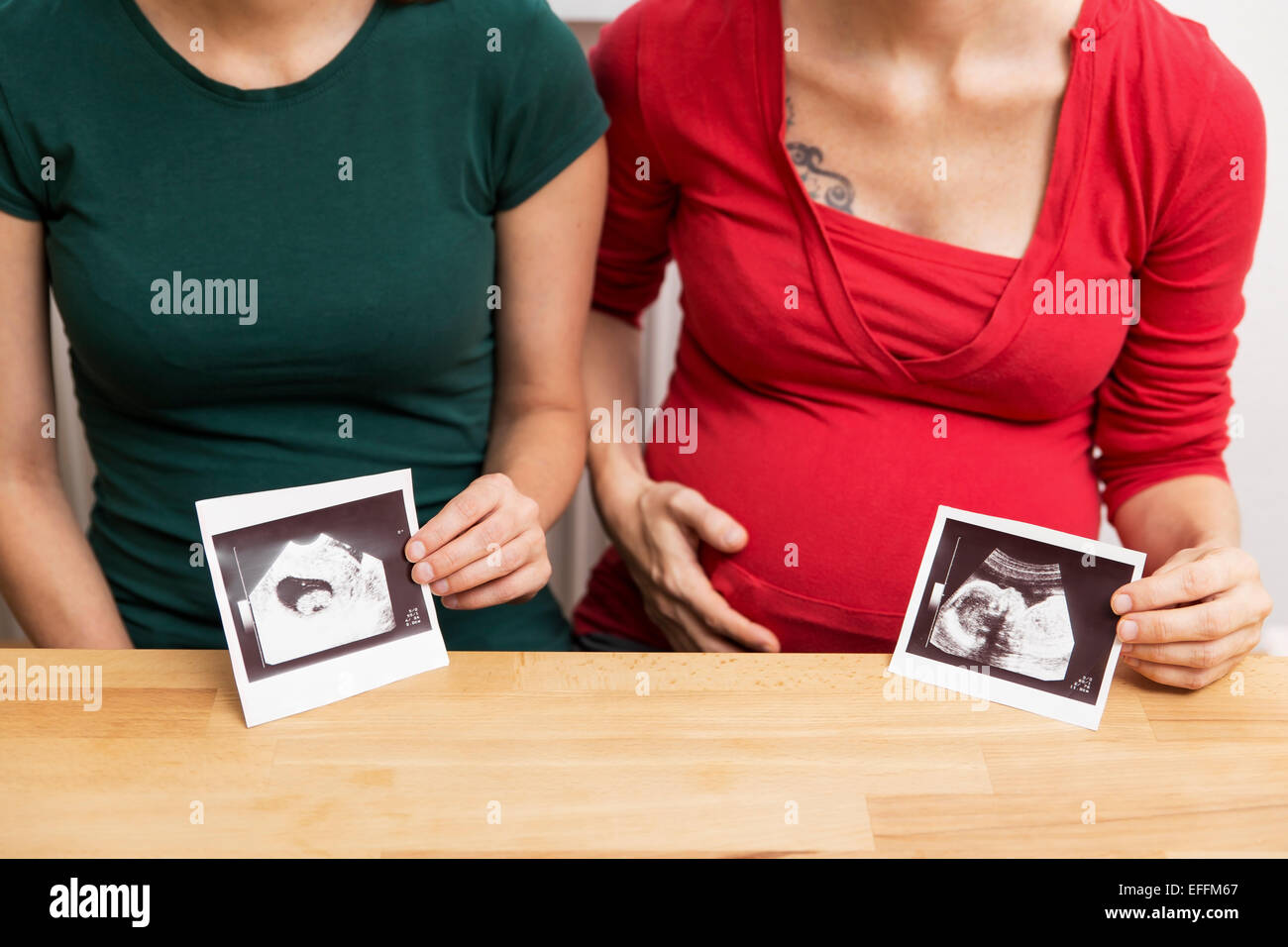 Pregnant woman and friend showing ultrasound scans Stock Photo - Alamy