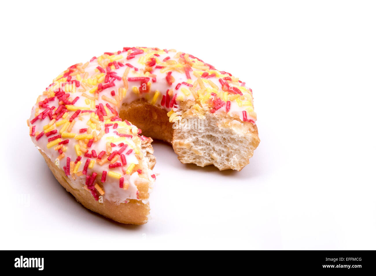 Iced ring donut with a bite out of it, against a white background Stock ...
