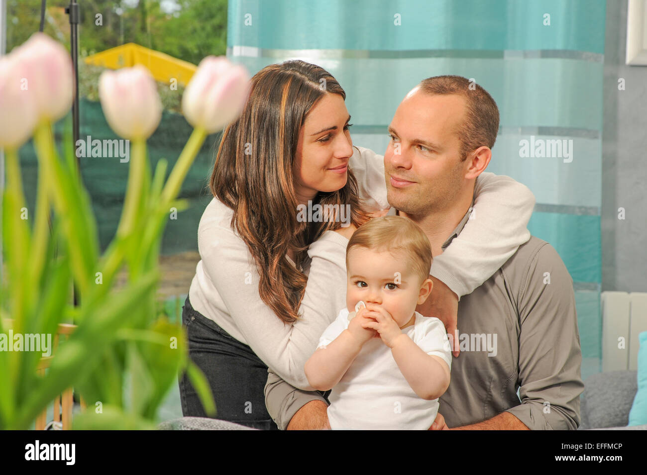 Parents Cuddling Newborn Baby Boy At Home Stock Photo - Alamy