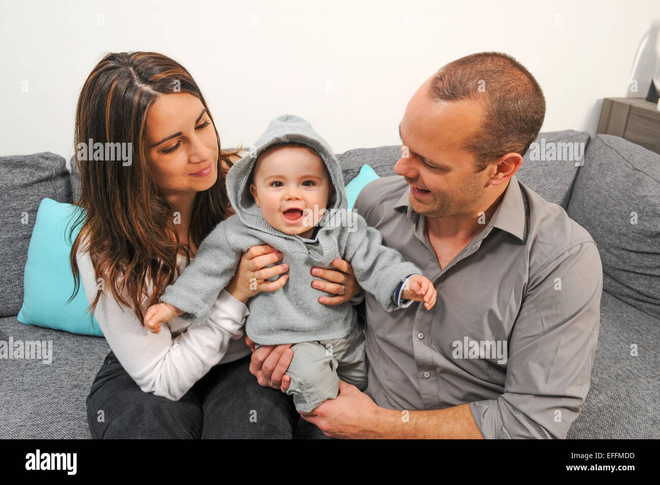 Parents Cuddling Newborn Baby Boy At Home Stock Photo - Alamy