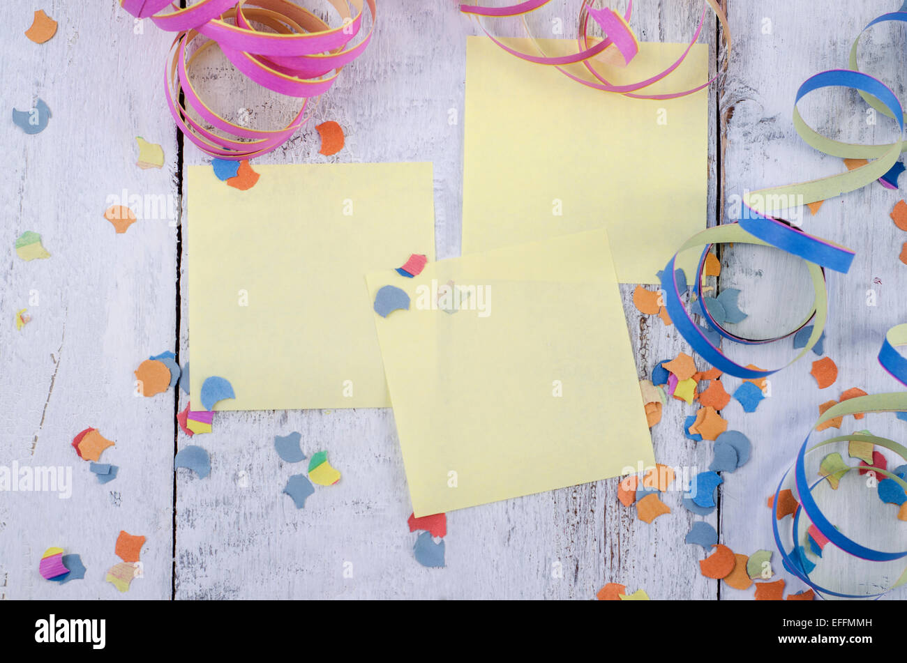 Three blank adhesive notes, confetti and streamers on wood Stock Photo ...
