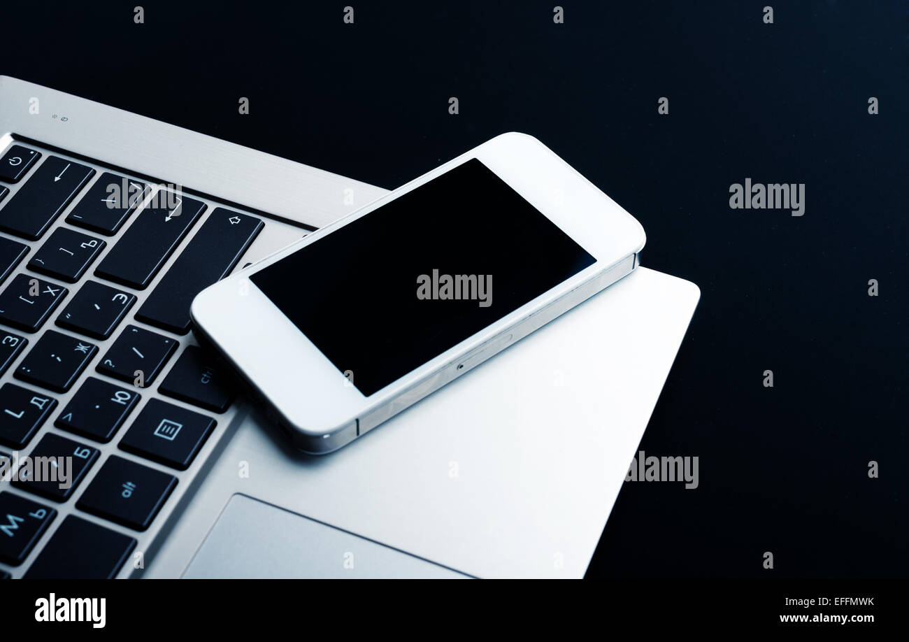 keyboard with phone and tablet pc on black background Stock Photo - Alamy