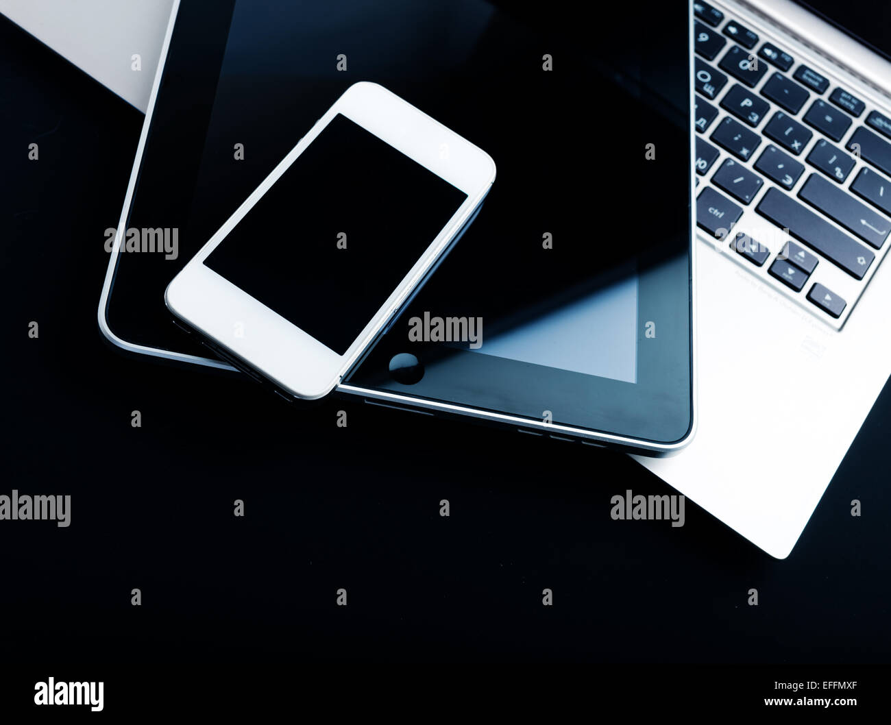 keyboard with phone and tablet pc on black background Stock Photo - Alamy