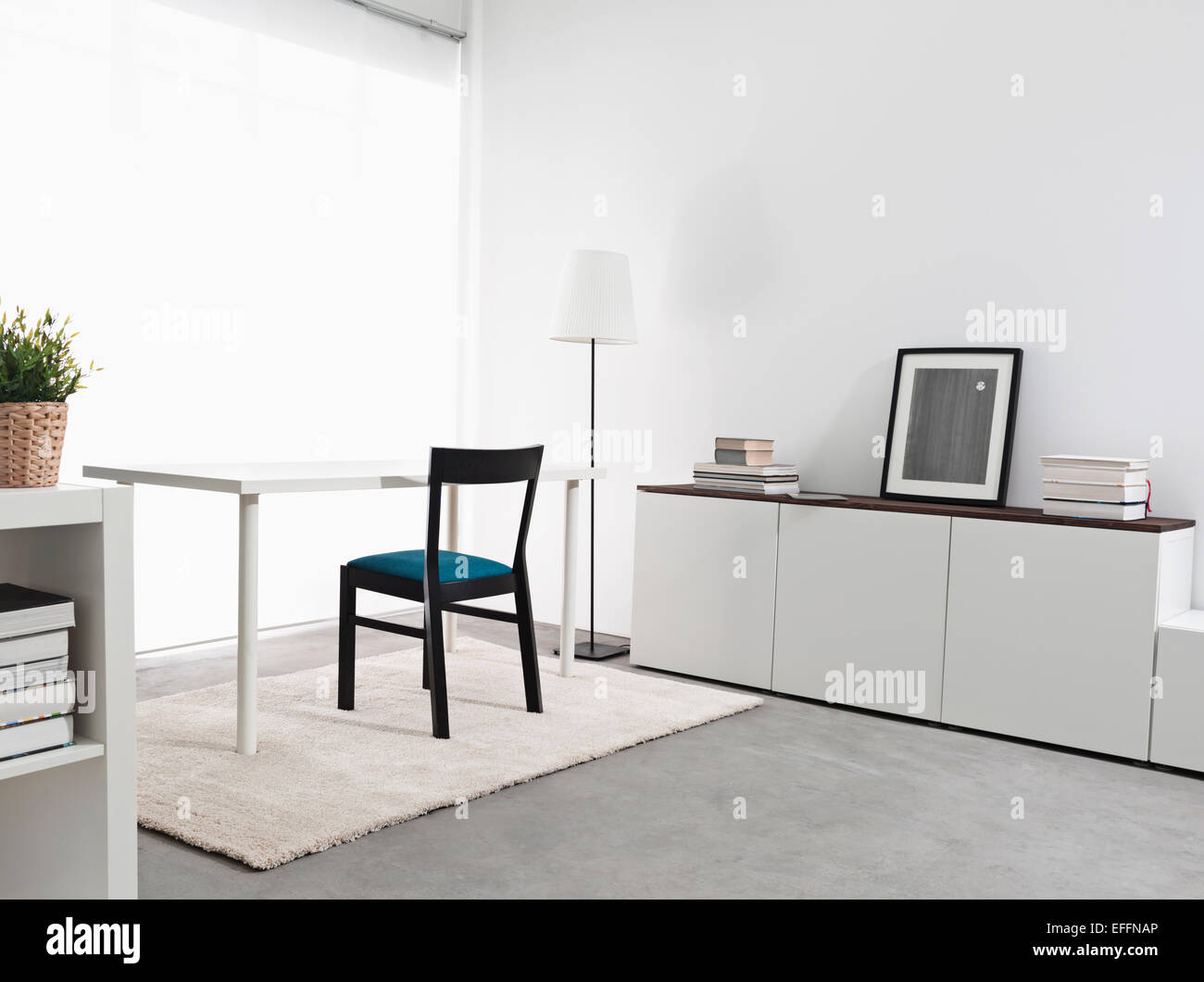Modern living room with sidebord and desk Stock Photo - Alamy