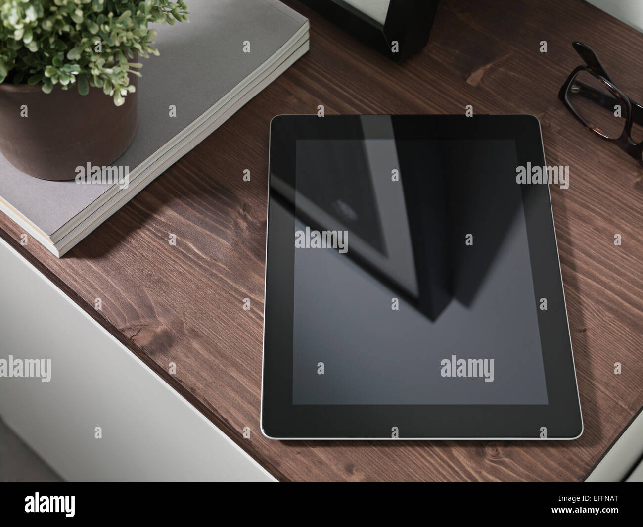 Digital tablet lying on sideboard Stock Photo - Alamy