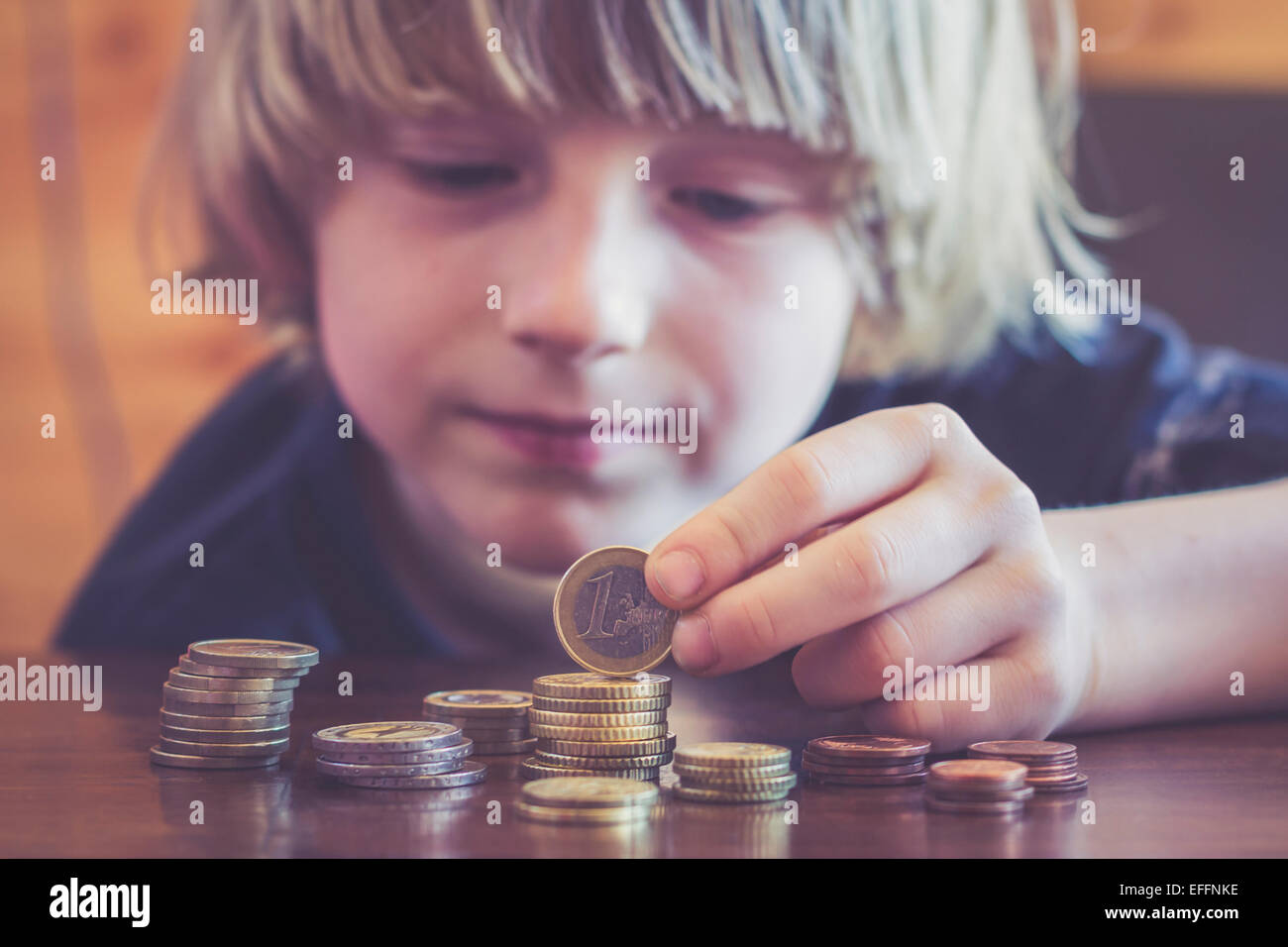 Little boy counting coins Stock Photo - Alamy