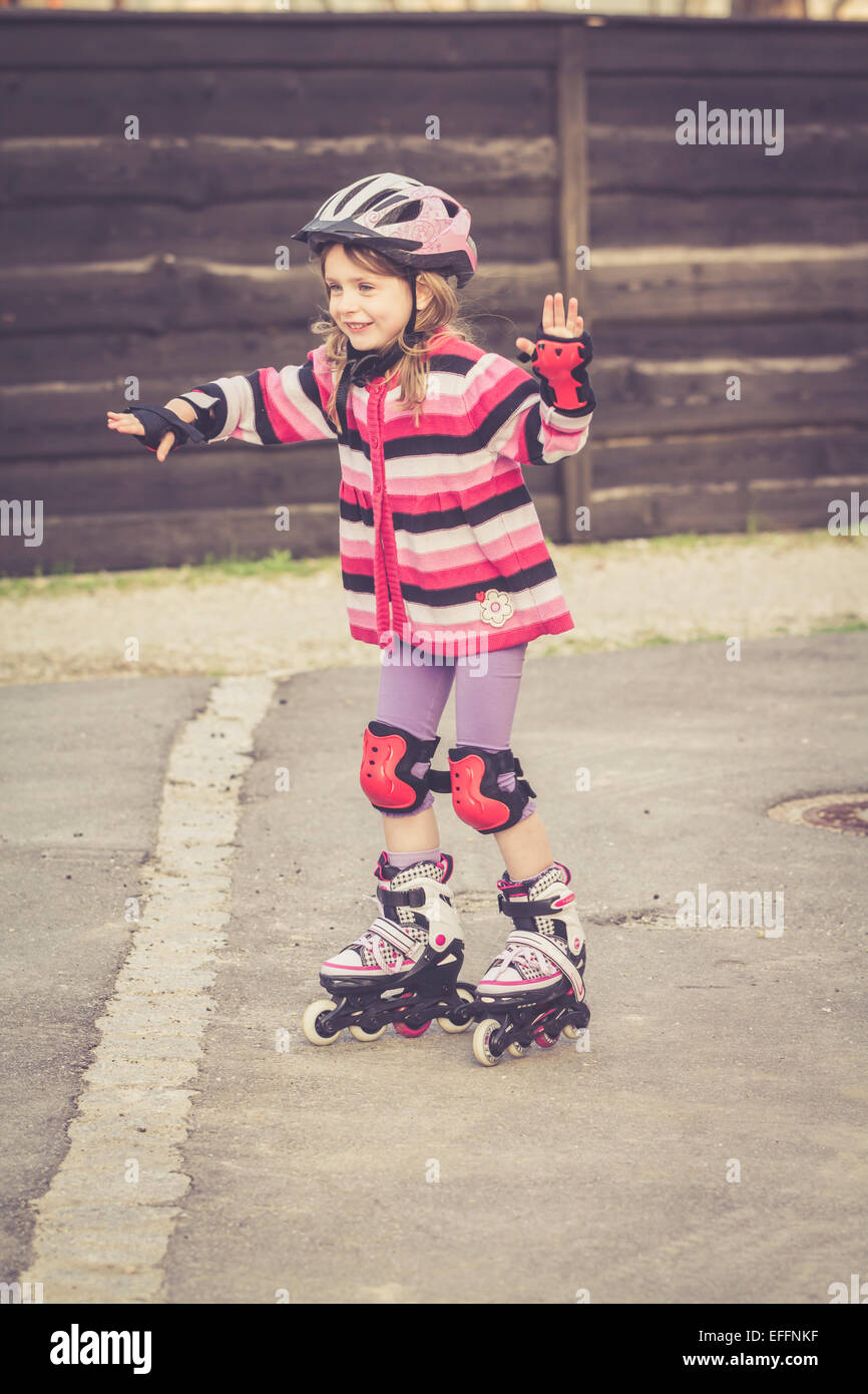Little girl balancing on rollerblades Stock Photo - Alamy