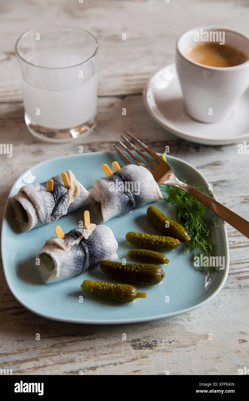 Dish of rollmops and pickled cucumbers, black coffee and fizzy tablet ...