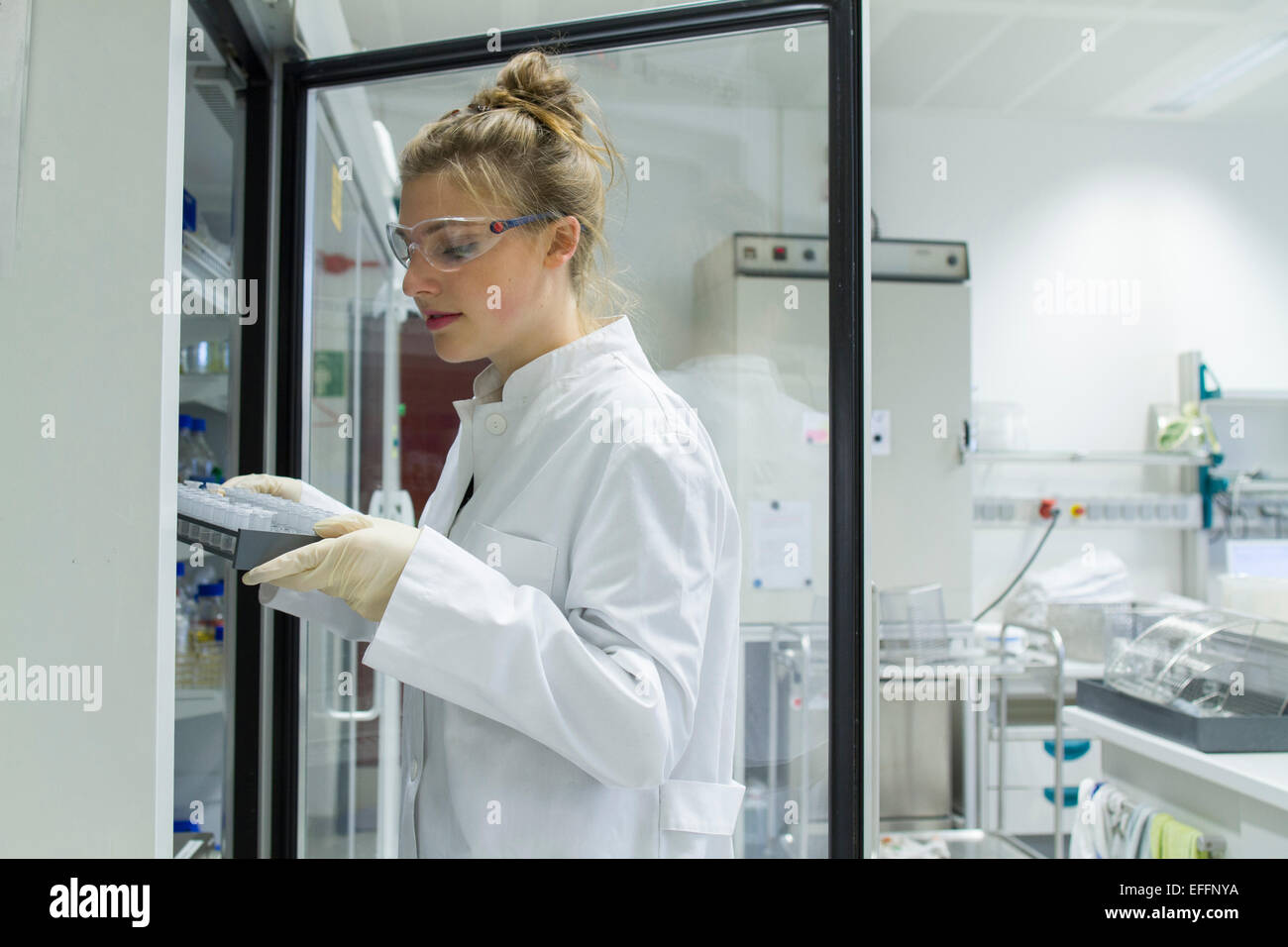 Biologist in laboratory holding rack Stock Photo - Alamy