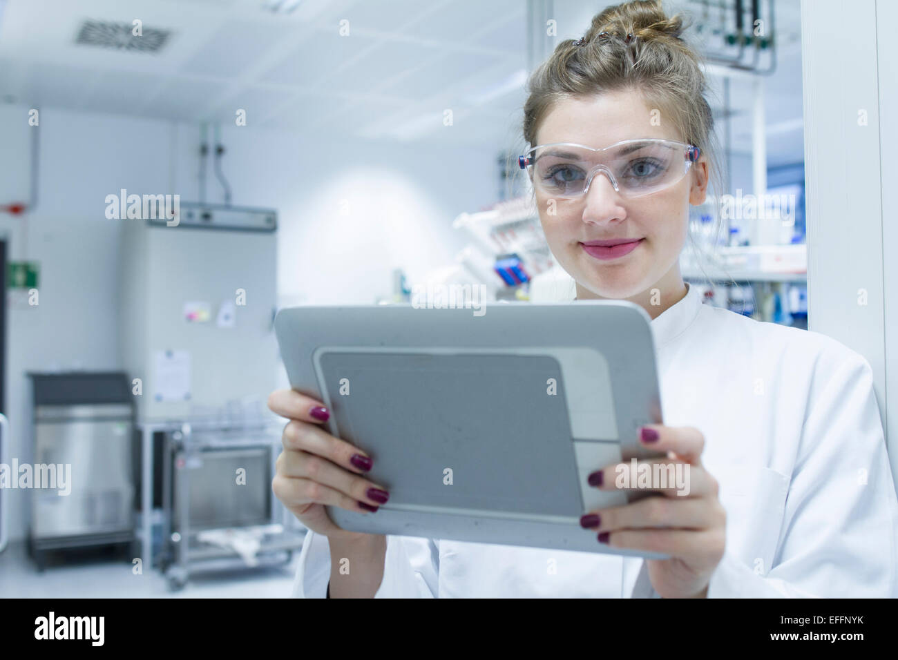 Portrait of scientist in laboratory holding digital tablet Stock Photo ...