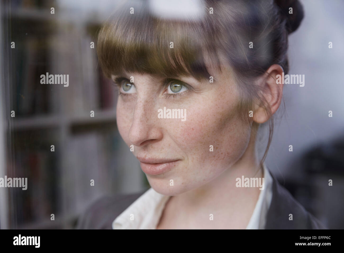 Woman behind glass pane Stock Photo - Alamy