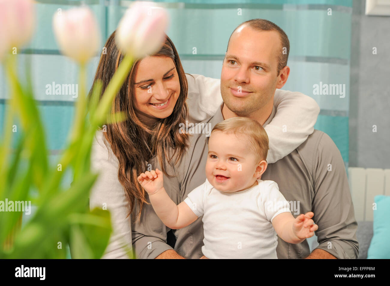 Parents Cuddling Newborn Baby Boy At Home Stock Photo - Alamy