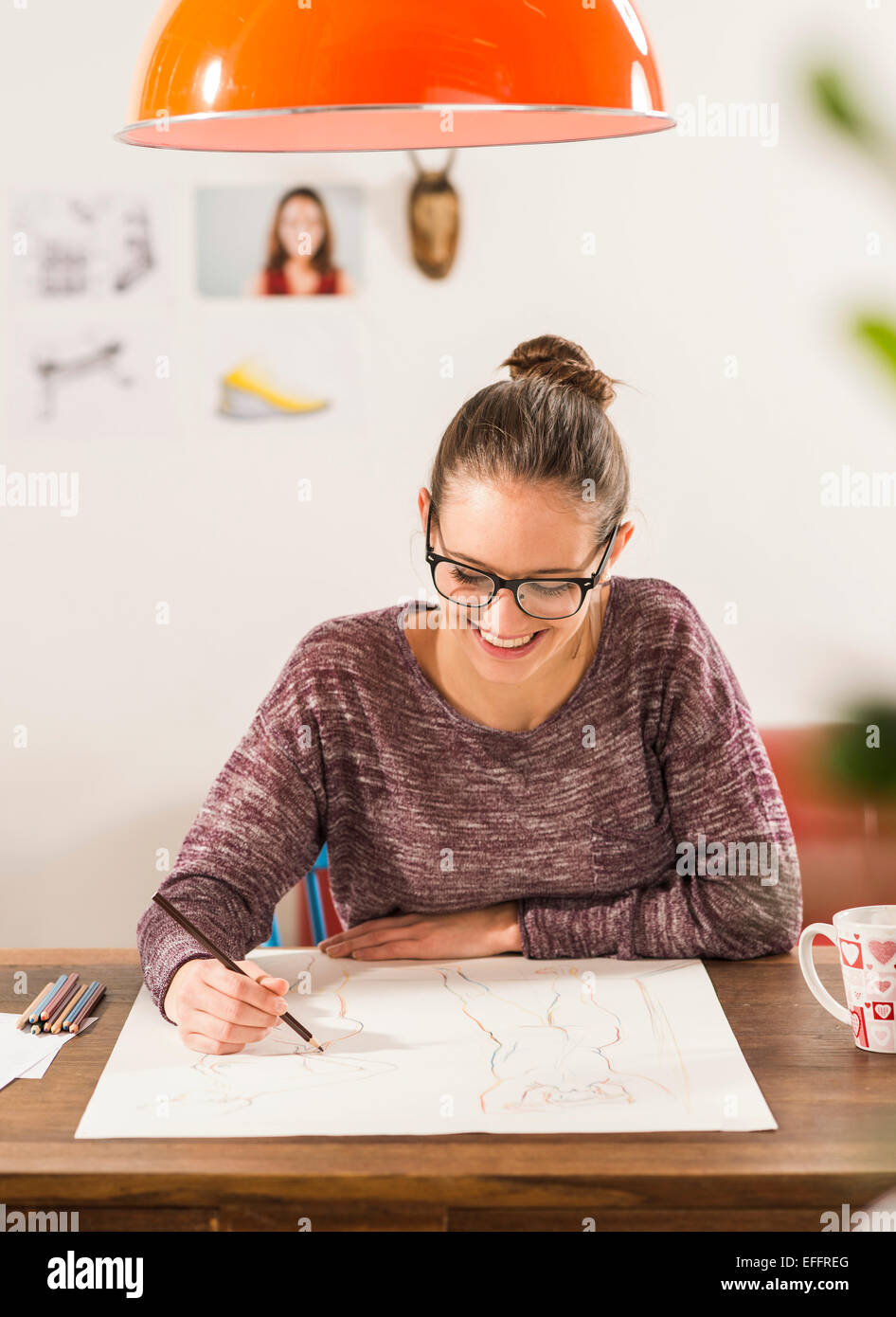 Young woman drawing at home Stock Photo - Alamy