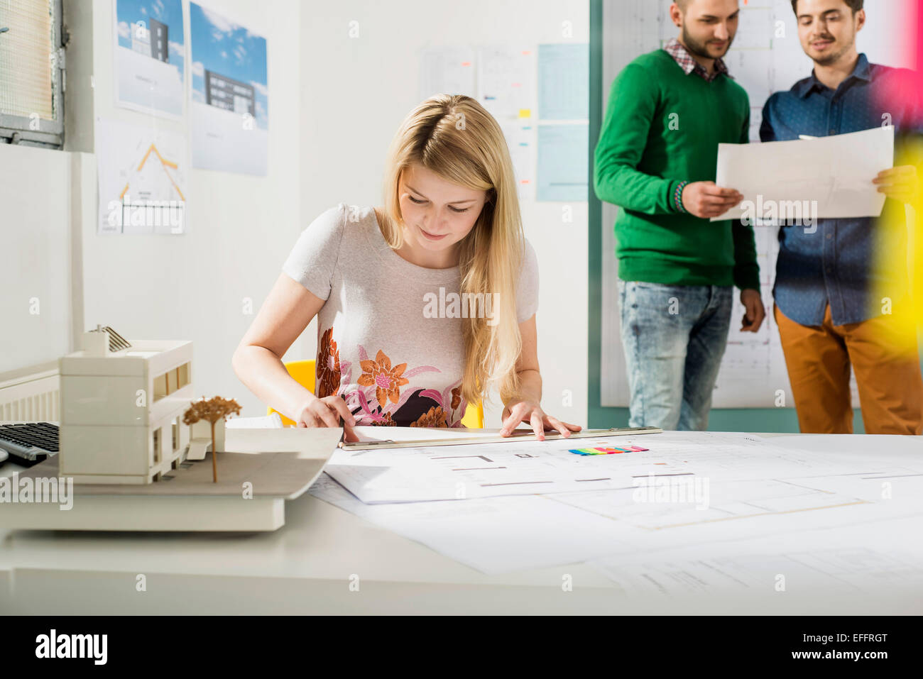 Three young architects in office Stock Photo - Alamy