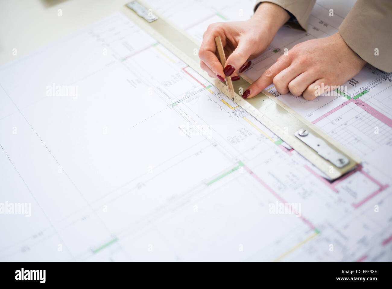 Close-up of architect working on construction plan Stock Photo - Alamy