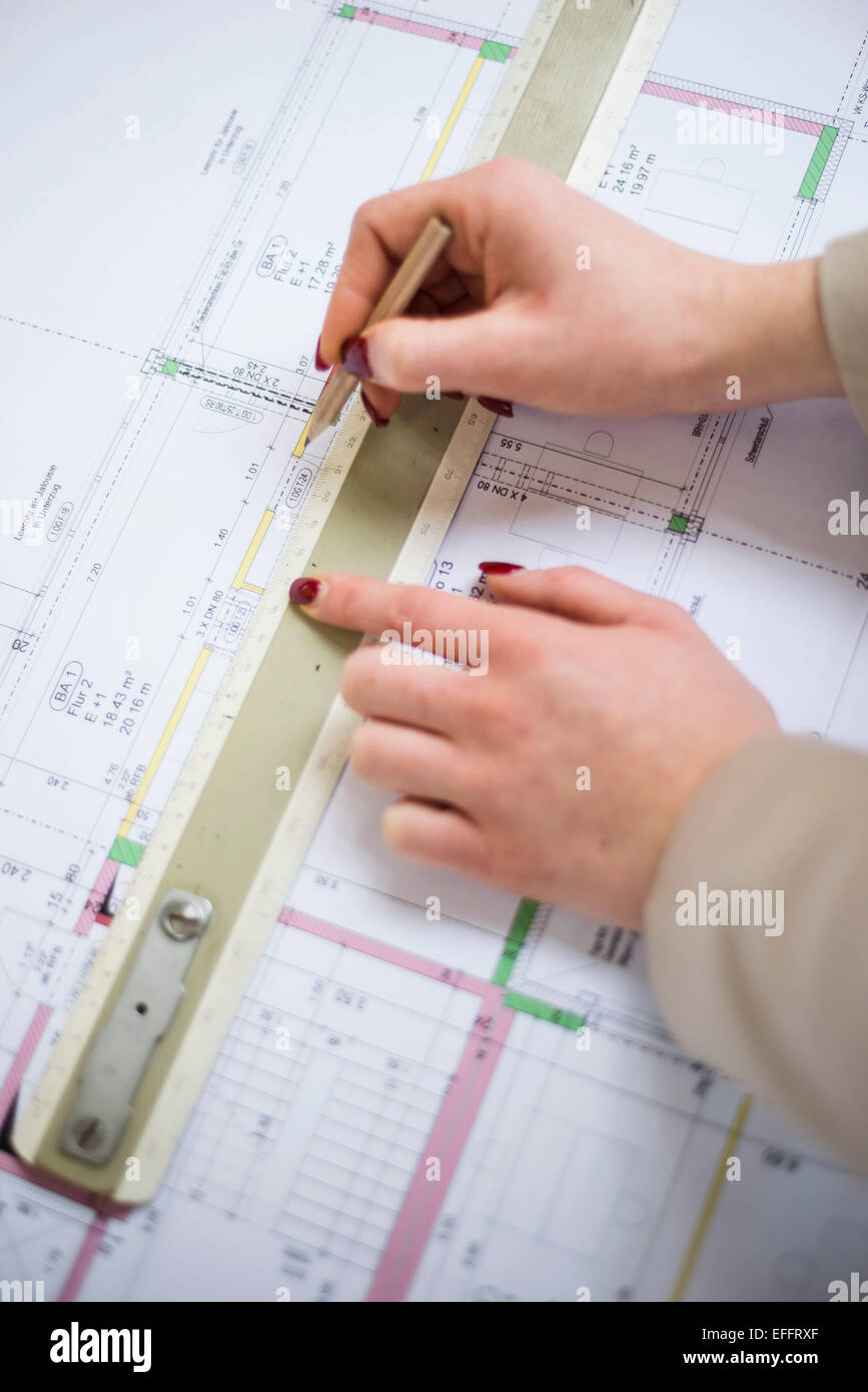 Close-up of architect working on construction plan Stock Photo - Alamy