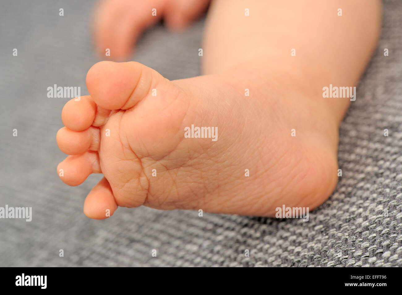 Baby touching feet hi-res stock photography and images - Alamy