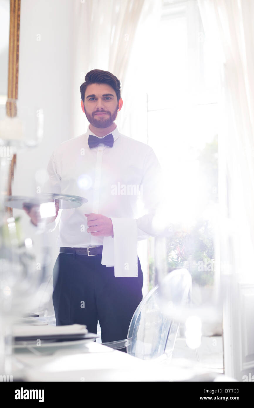Elegant waiter in restaurant Stock Photo - Alamy
