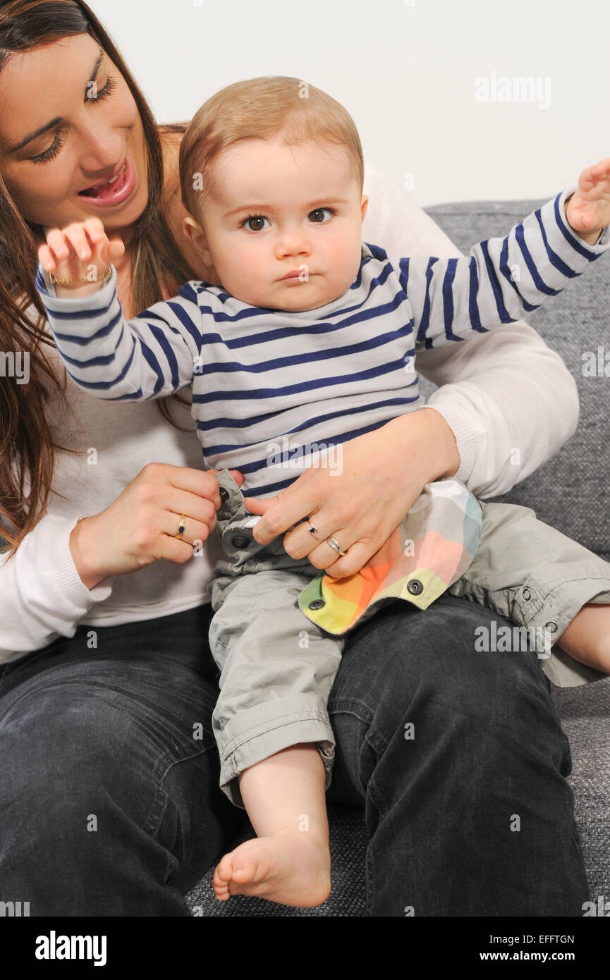 Loving mother kissing embracing baby hi-res stock photography and ...