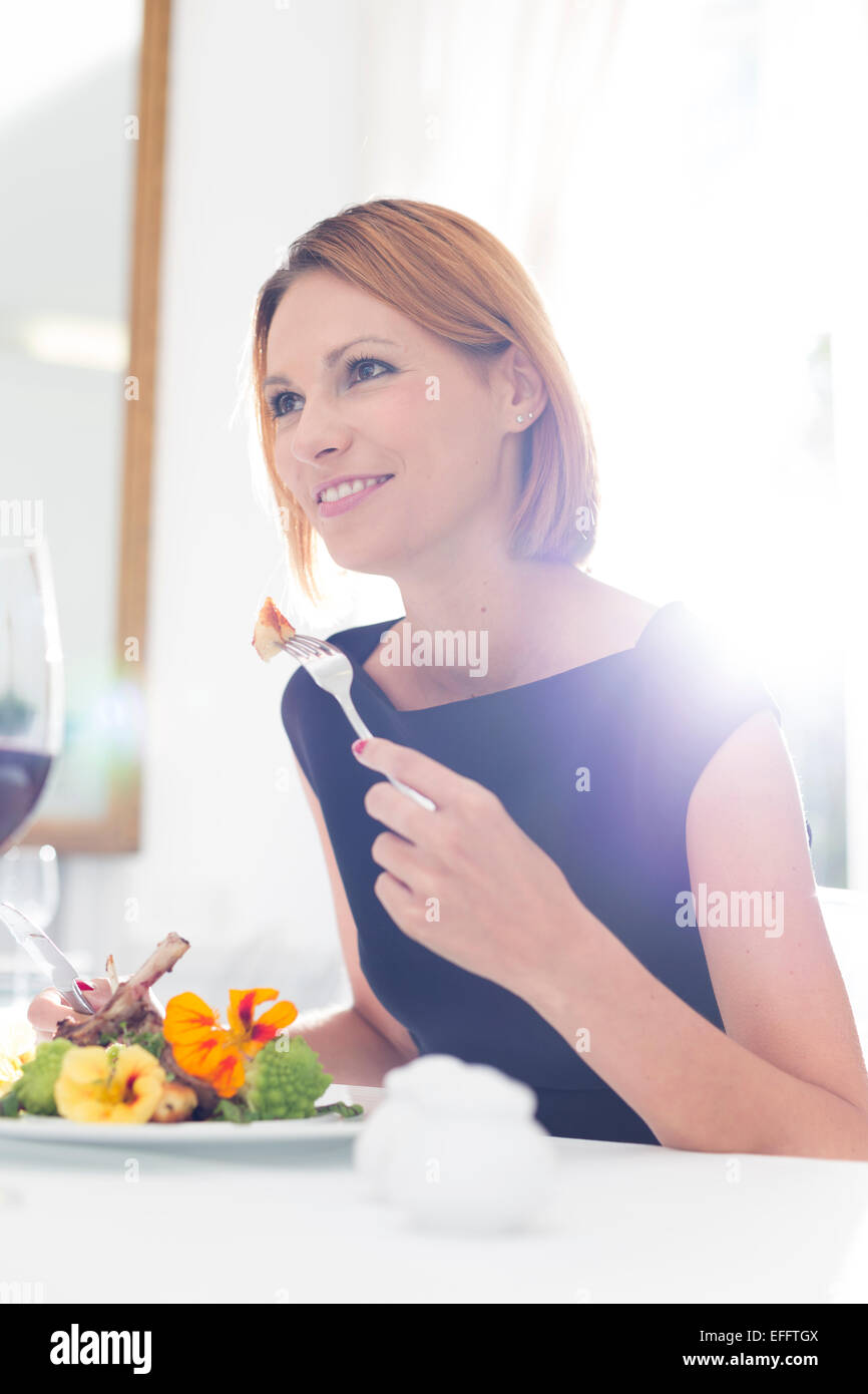 Elegant woman having dinner in restaurant Stock Photo - Alamy