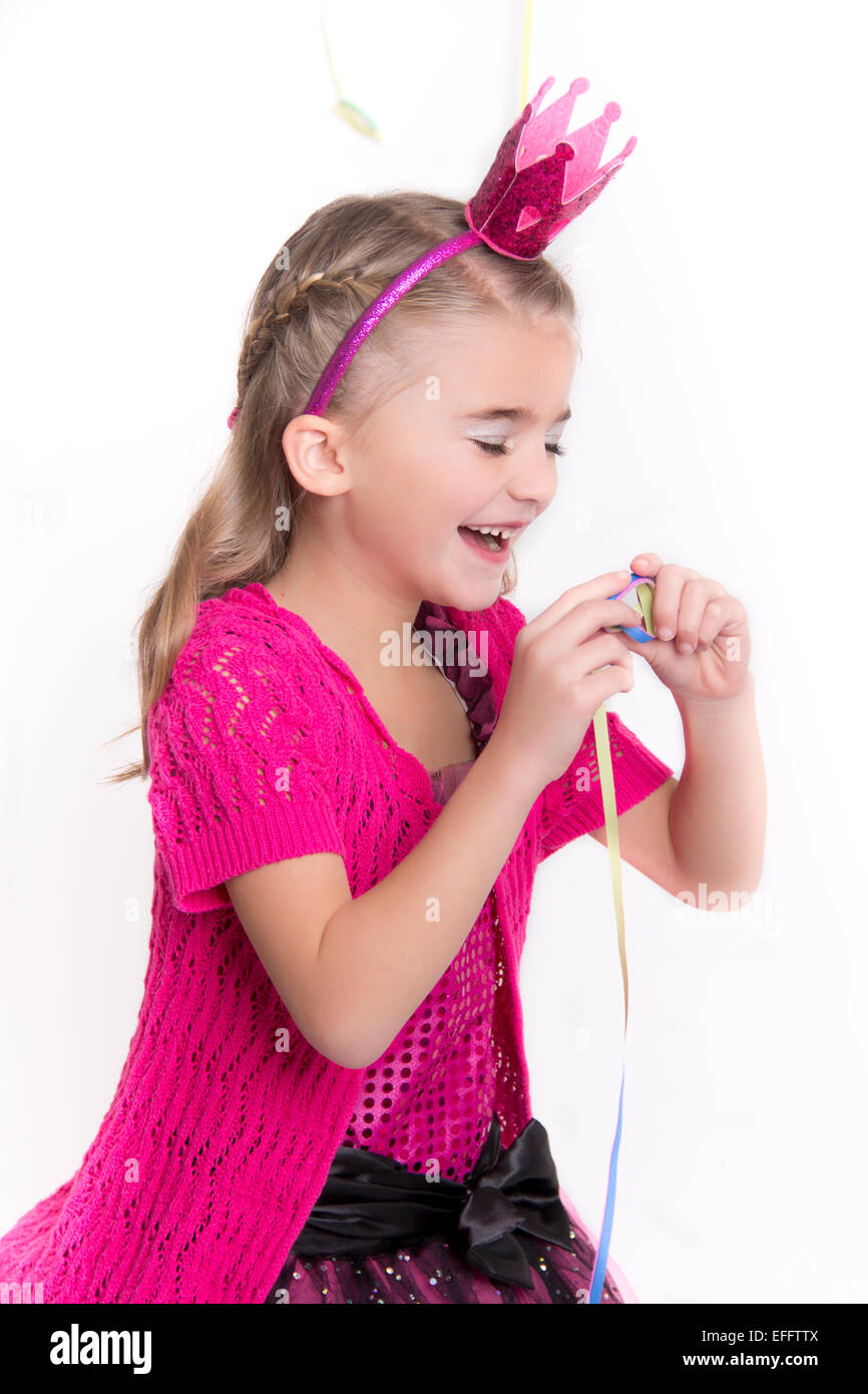 Laughing little girl masquerade as a princess holding streamer Stock ...