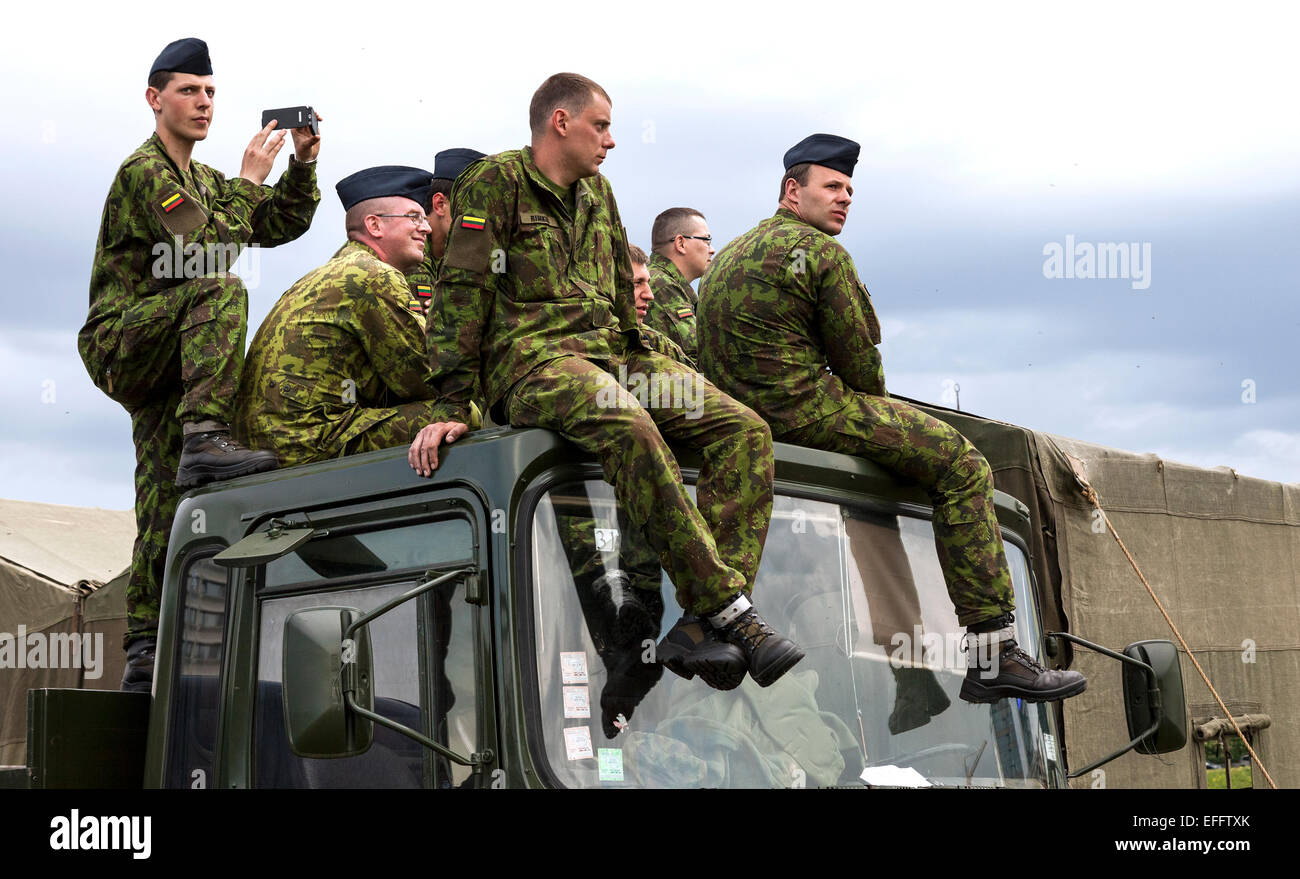 Lithuanian army soldiers sitting on the top of military truck during ...