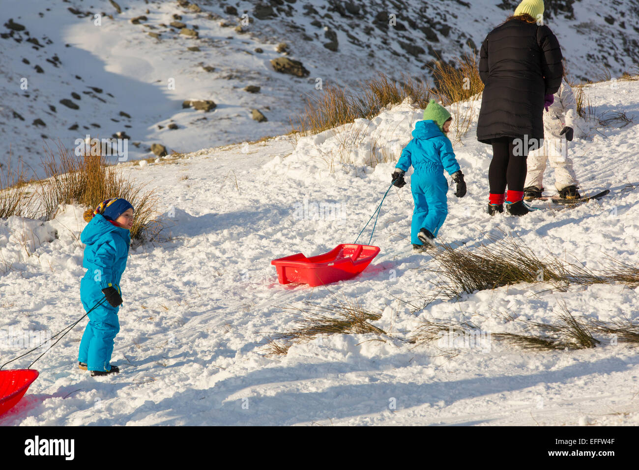 A family sledging on Kirkstone Pass in the Lake District, UK Stock ...