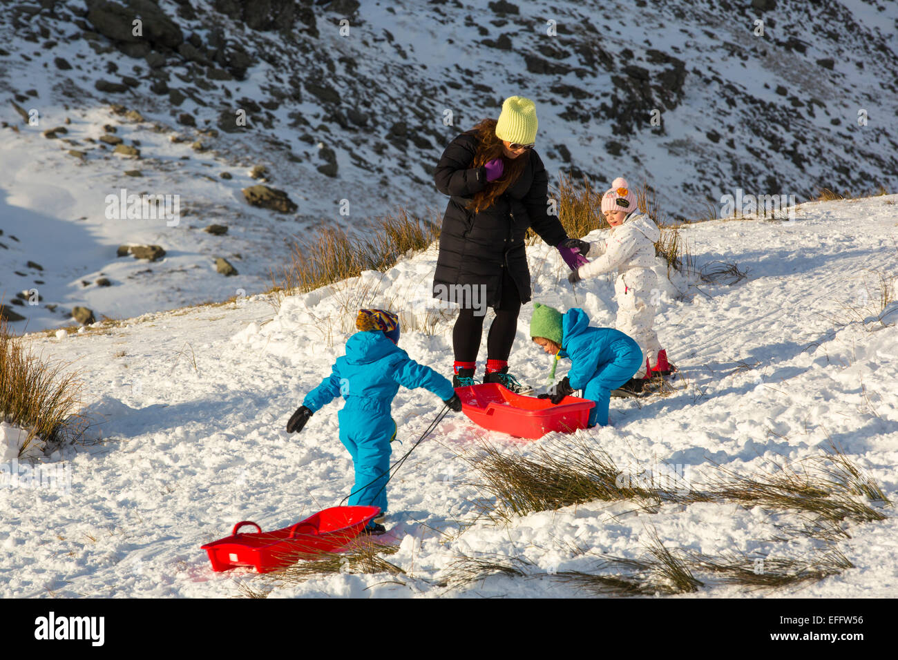 A family sledging on Kirkstone Pass in the Lake District, UK Stock ...