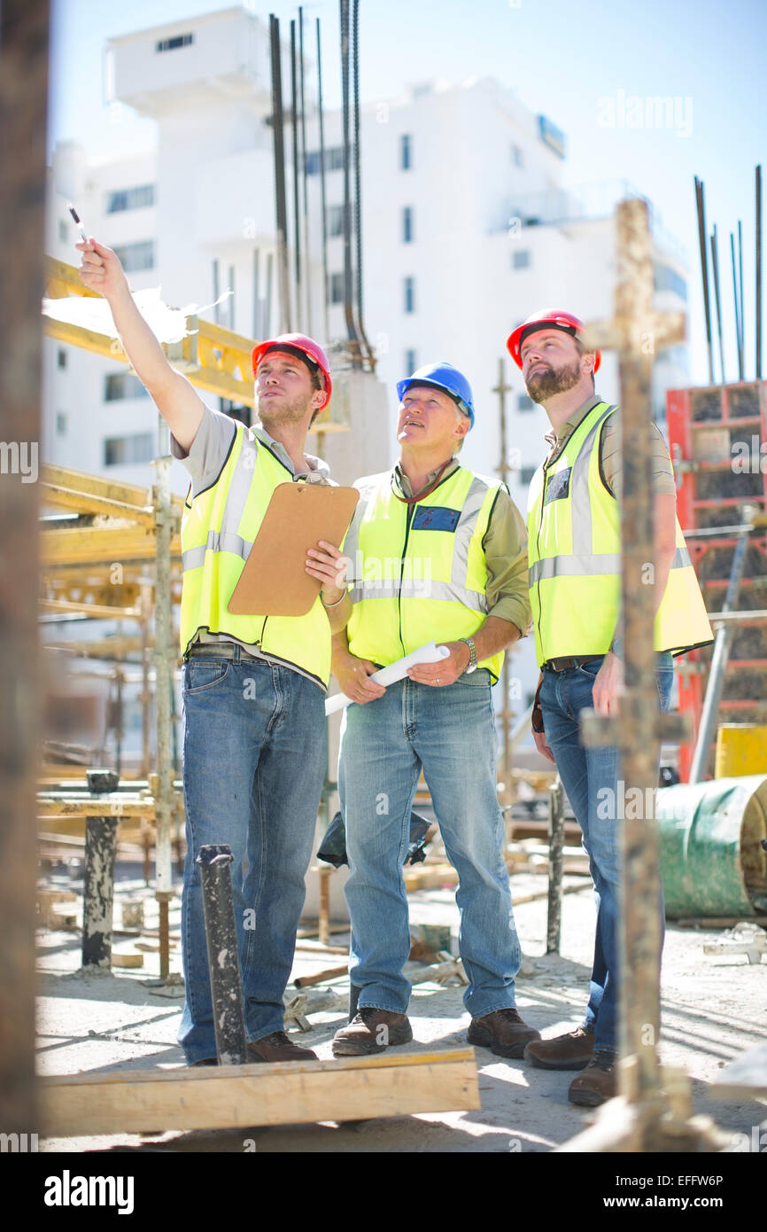 Three construction workers in construction site Stock Photo - Alamy