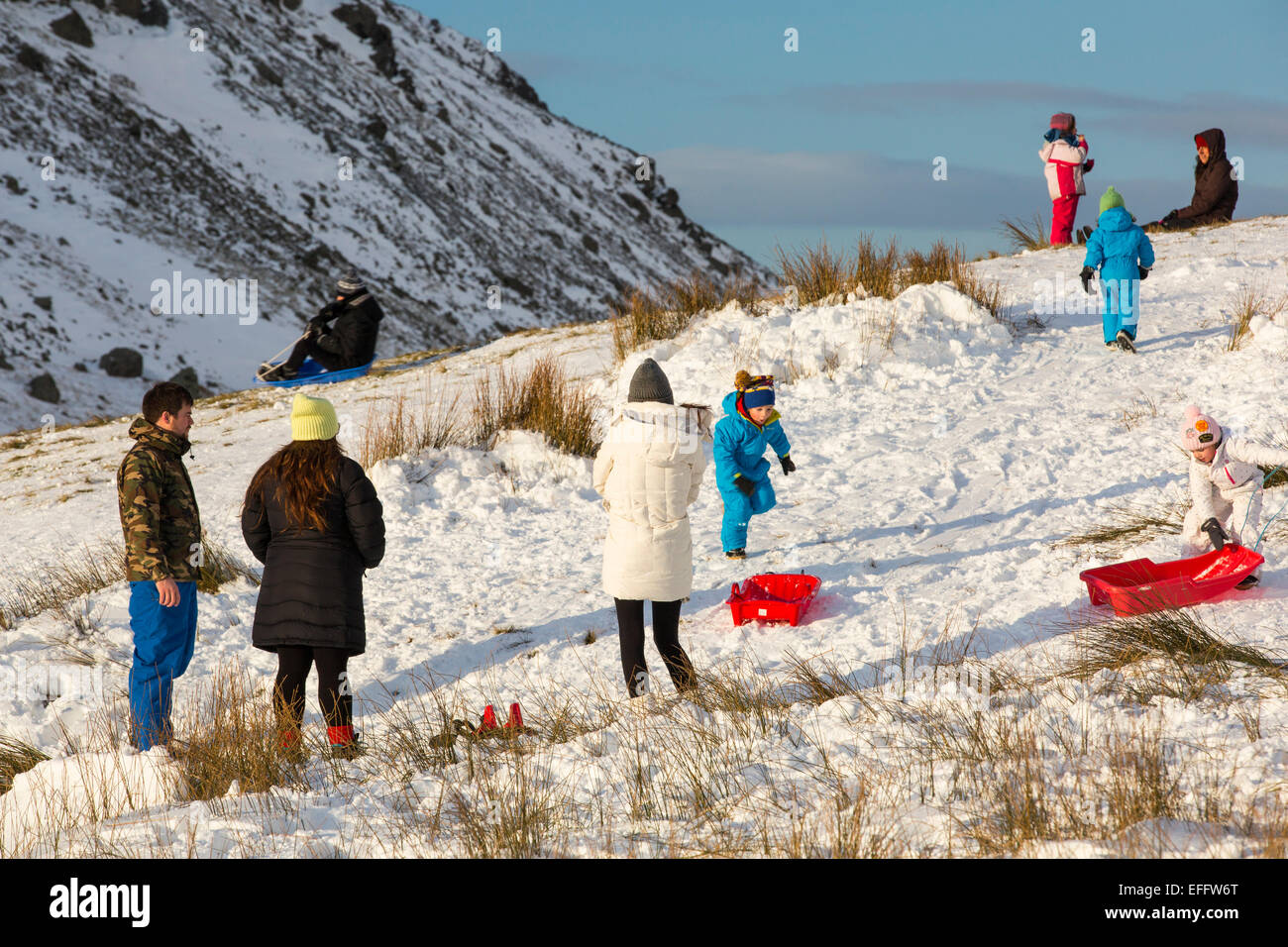 A family sledging on Kirkstone Pass in the Lake District, UK Stock ...