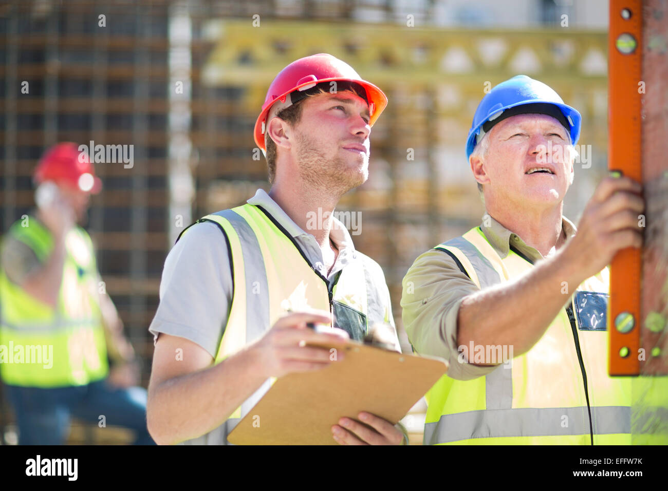 Construction workers using spirit level Stock Photo - Alamy