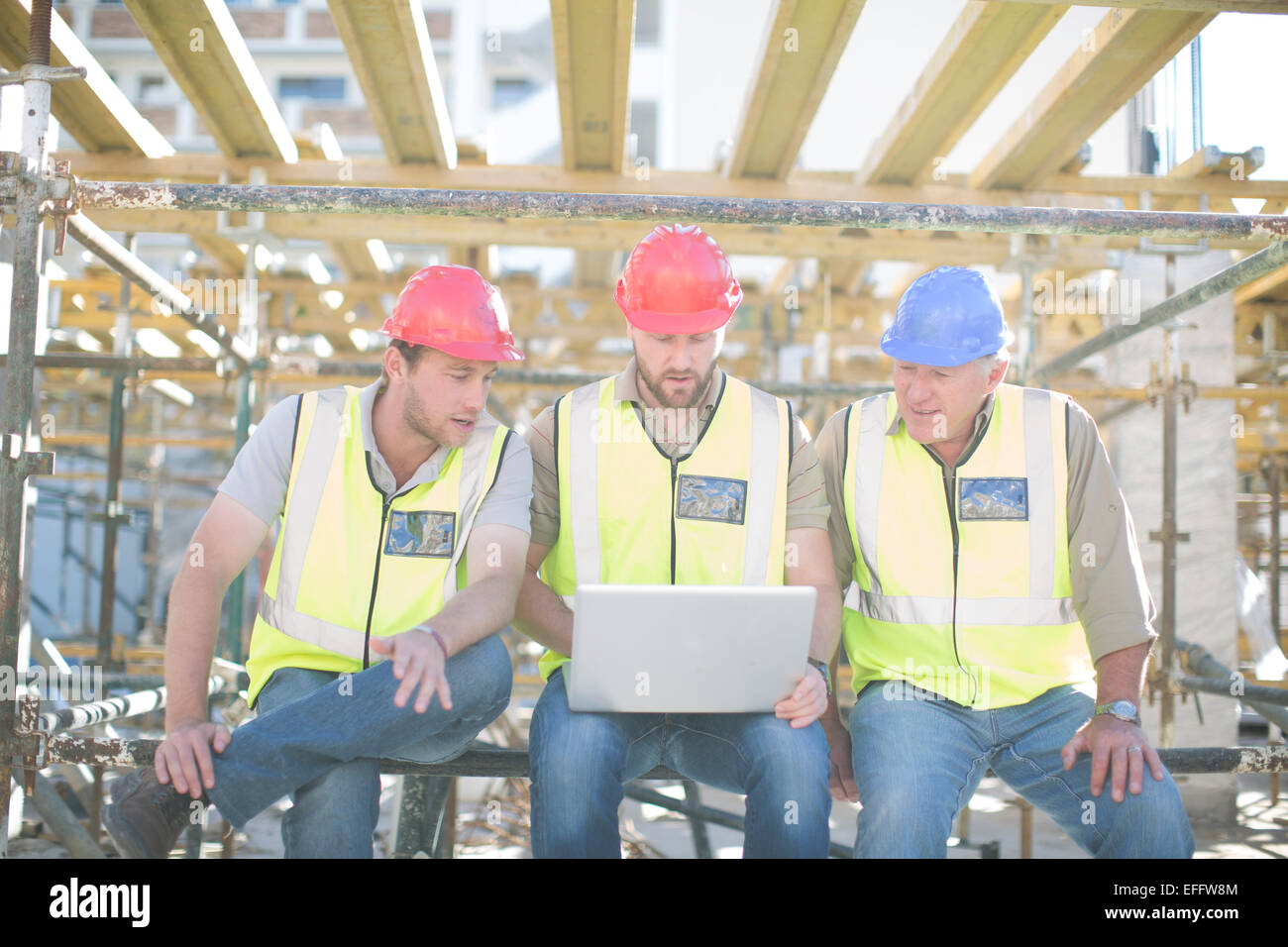 Construction workers with laptop having a break Stock Photo - Alamy