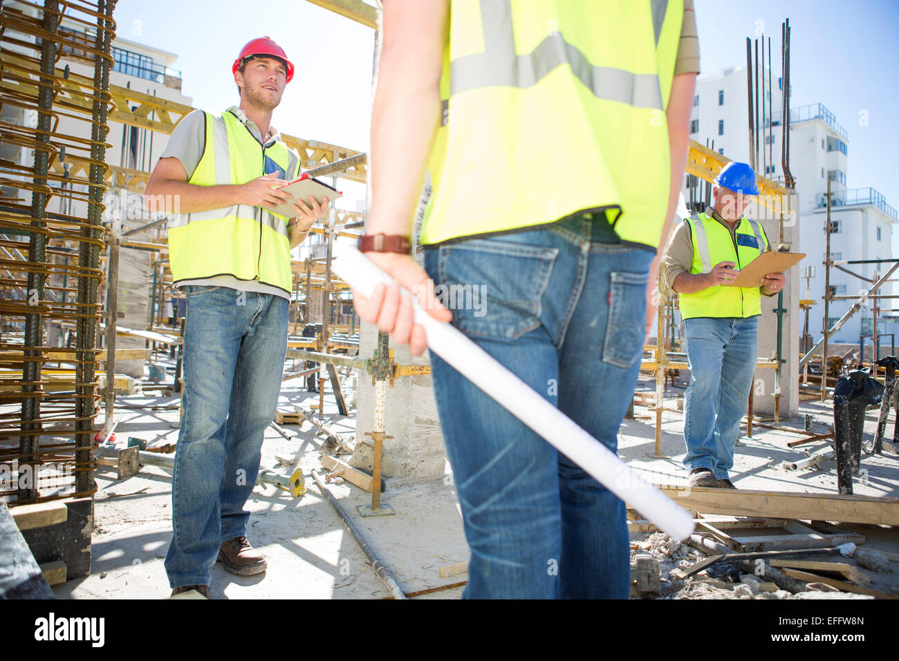 Three construction workers discussing in construction site Stock Photo ...