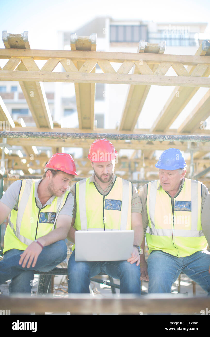 Construction workers with laptop having a break Stock Photo - Alamy