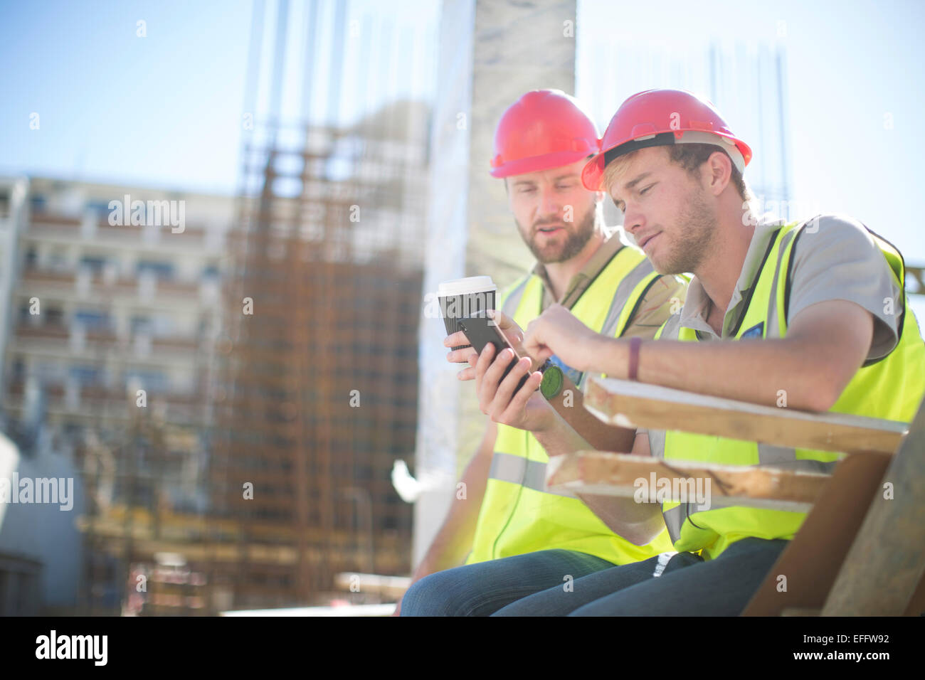 Construction workers having a break in construction site Stock Photo ...