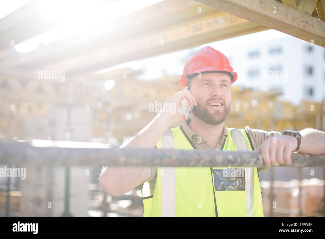 Construction worker on cell phone on construction site Stock Photo - Alamy