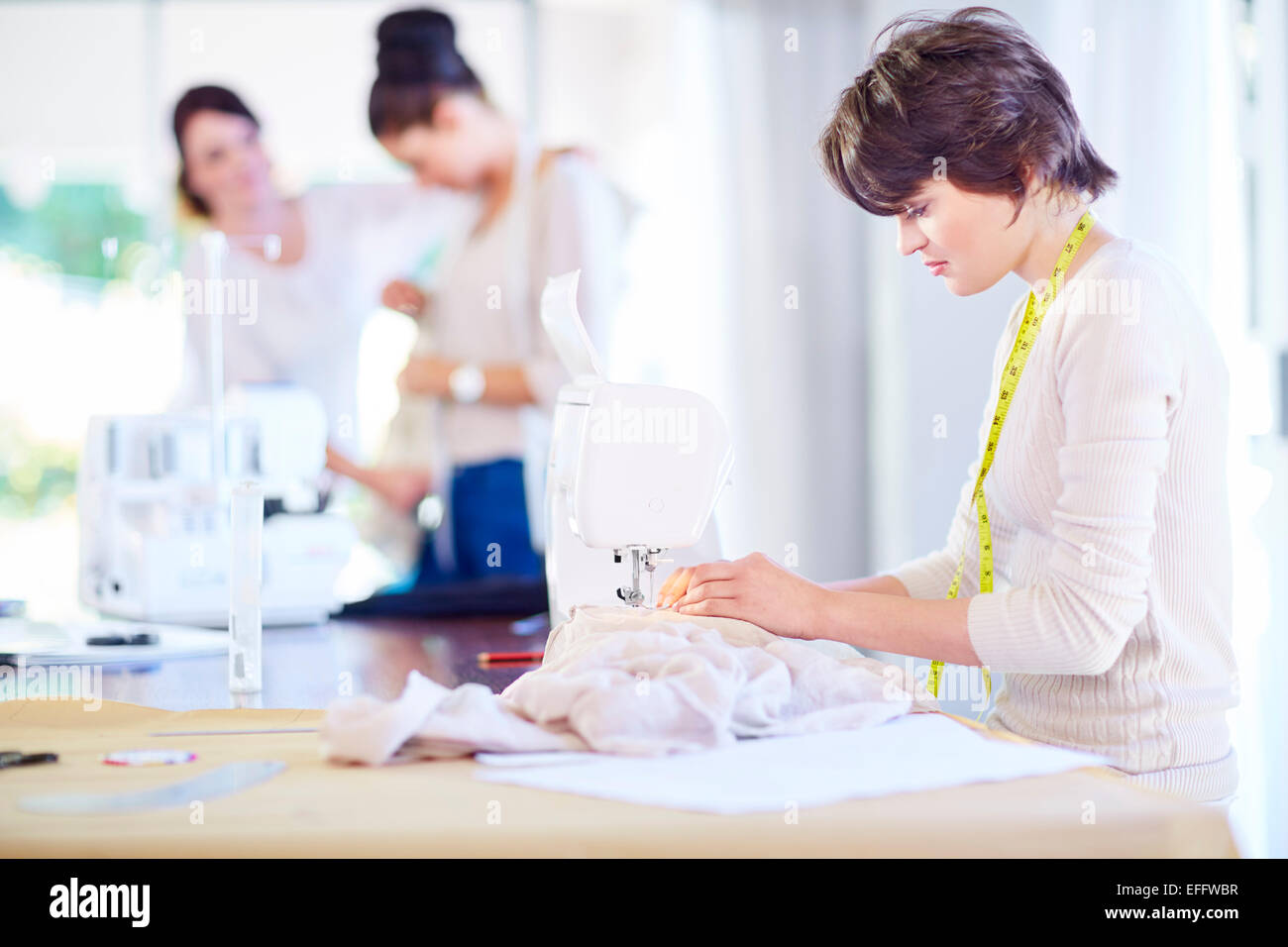 Seamstress working on sewing machine Stock Photo - Alamy