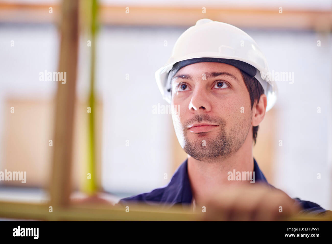 Construction worker measuring wood frame Stock Photo - Alamy