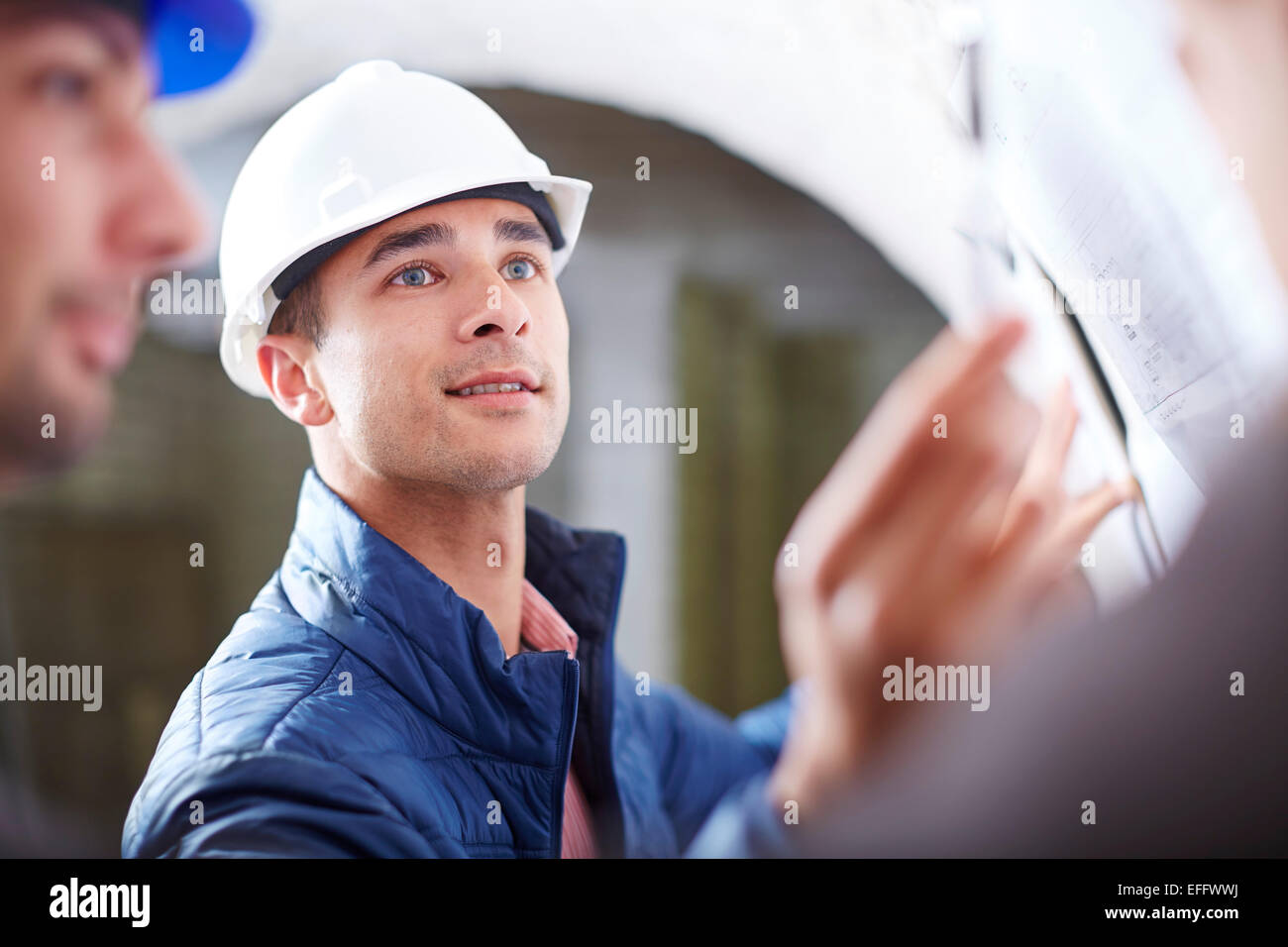 Construction workers discussing building plans Stock Photo - Alamy