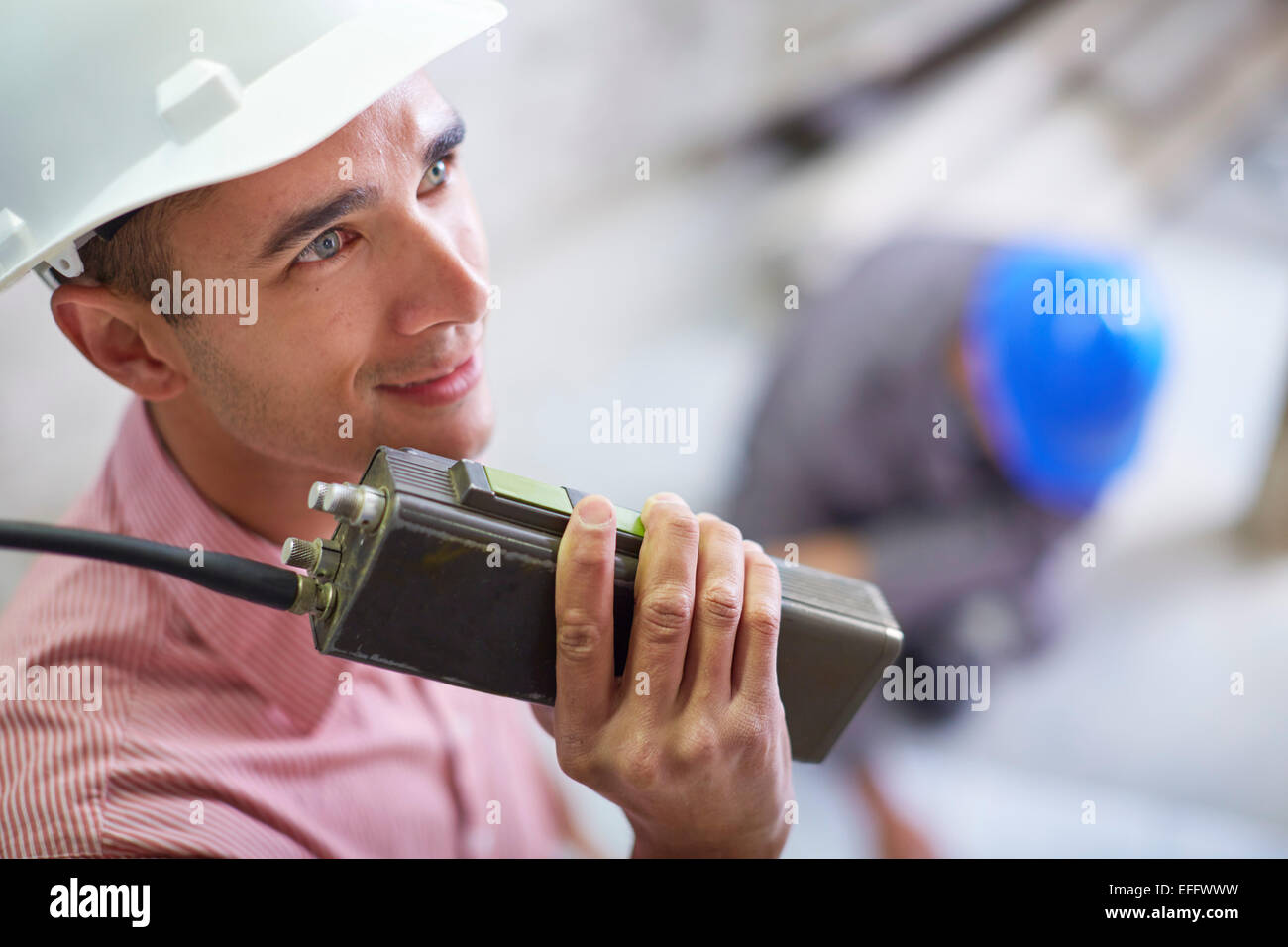 Construction worker talking on two-way radio Stock Photo - Alamy