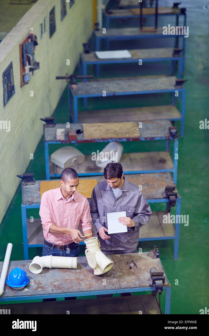 Construction worker and foreman discussing plumbing pipes Stock Photo ...