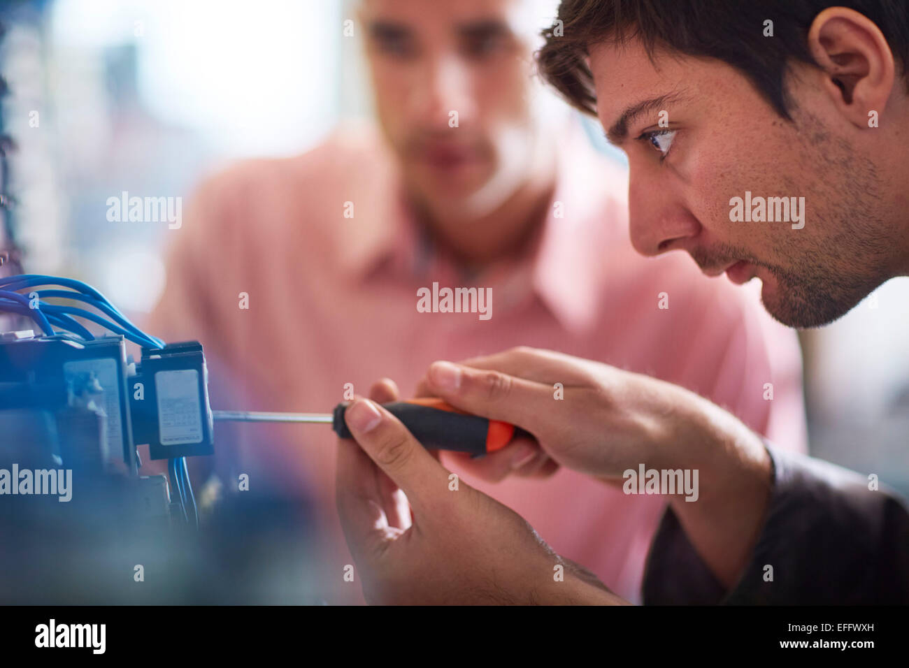 Electrician working with screw driver Stock Photo - Alamy