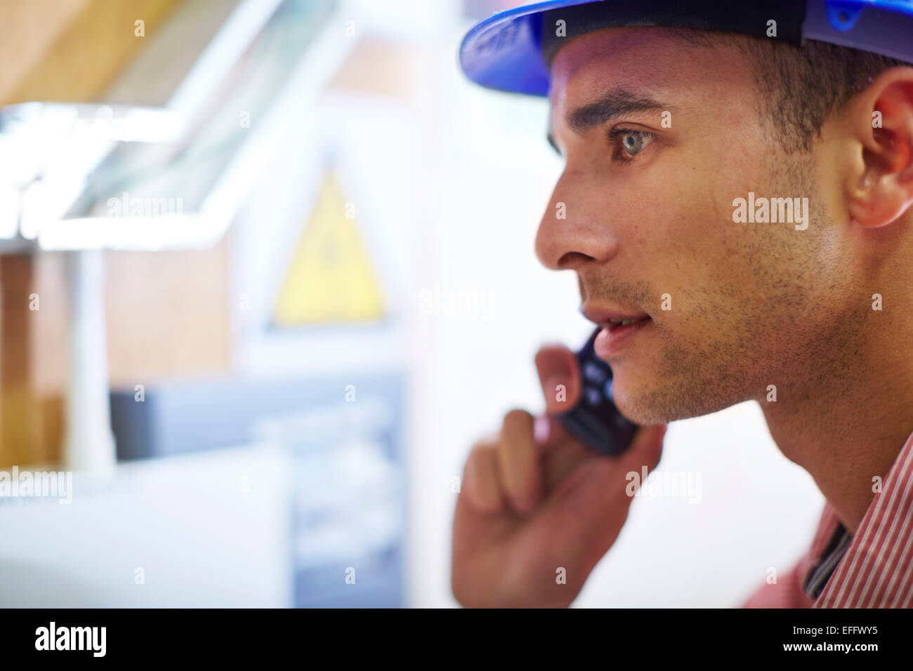 Man with hard hat on cell phone Stock Photo - Alamy