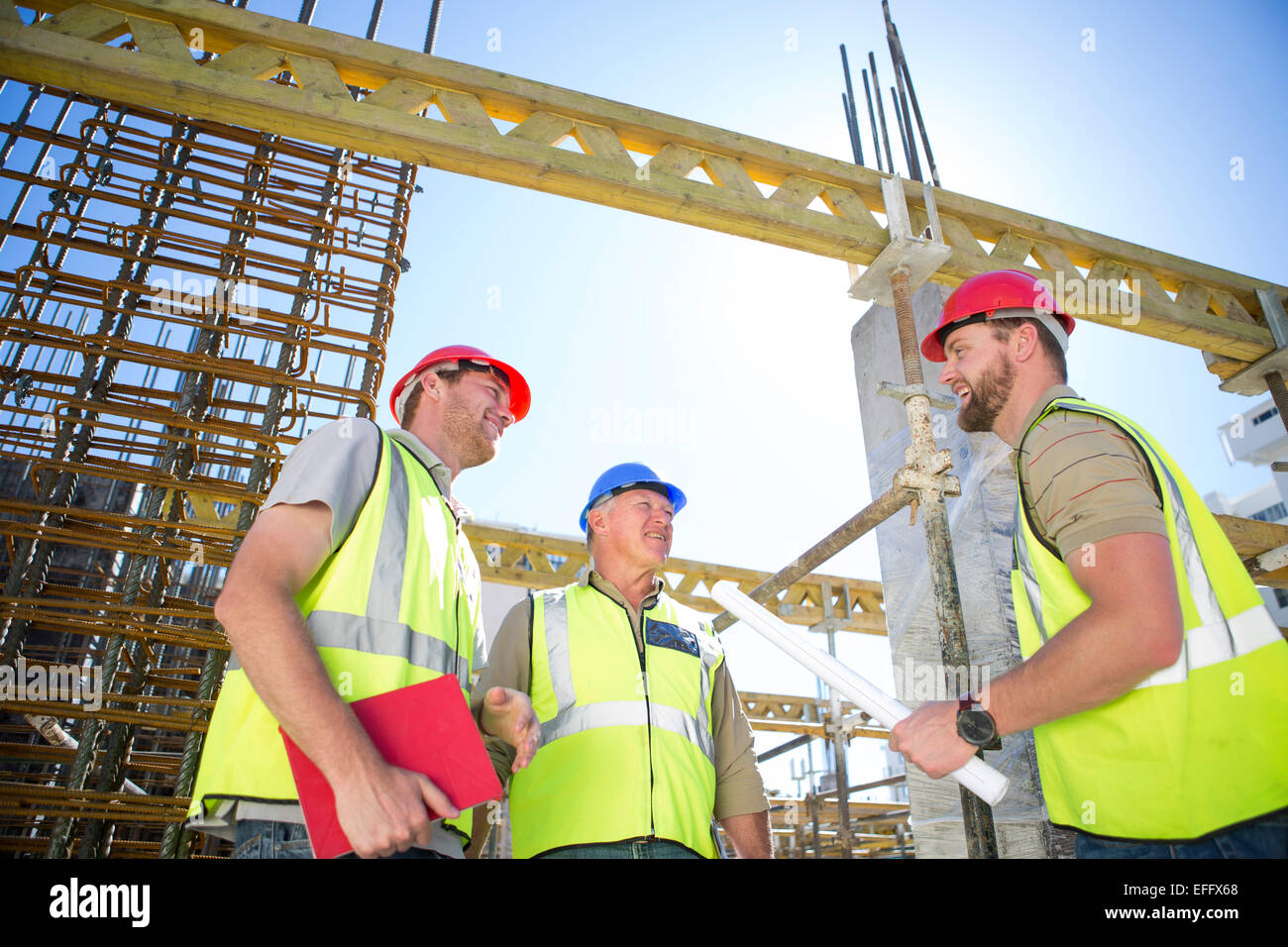 Three construction workers in construction site Stock Photo - Alamy