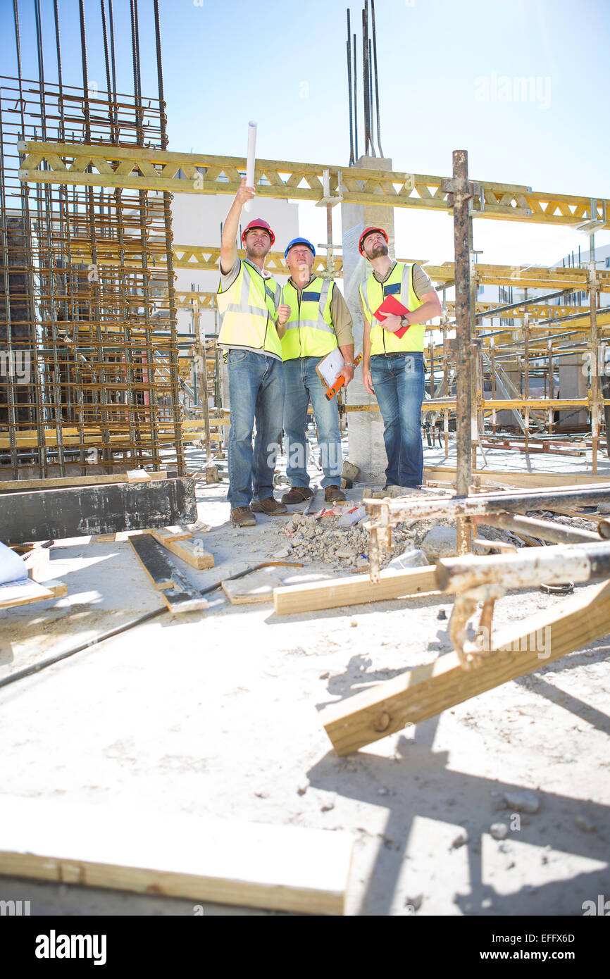 Three construction workers in construction site Stock Photo - Alamy